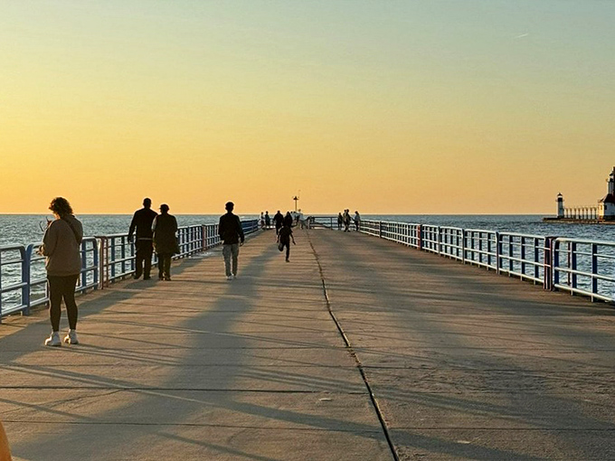 Sunset strollers enjoy Michigan's most romantic walkway, where every step offers postcard-worthy views and fresh Great Lakes breezes.