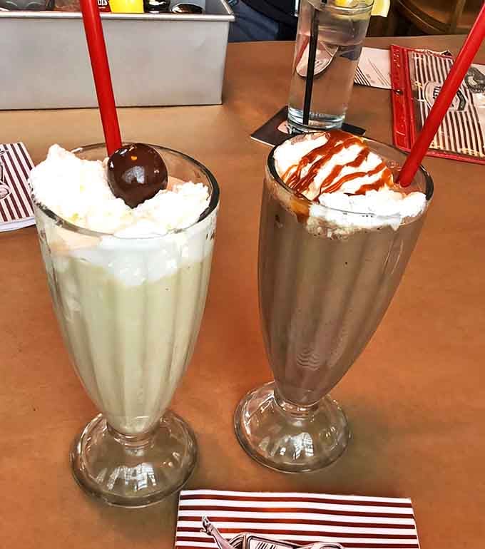 Adult Milkshakes: Two glasses of pure indulgence &ndash; one crowned with a cherry, the other drizzled with caramel &ndash; proof that growing up doesn't mean giving up life's sweetest pleasures.