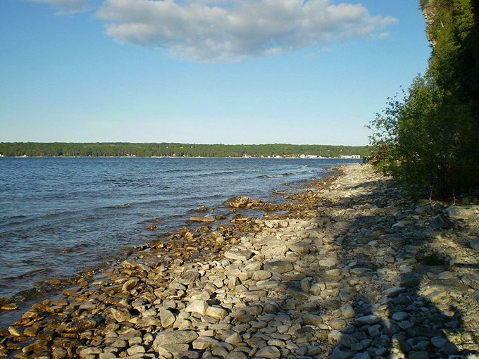 Crystal clear waters lap against the ancient limestone shore, creating a geological timeline you can actually walk on.