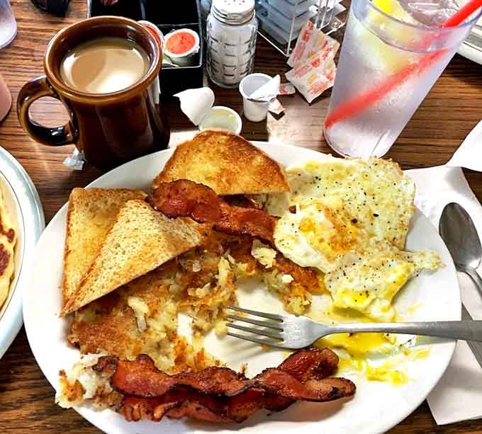 Morning glory on a plate: crispy hash browns, perfectly cooked eggs, bacon, and toast – the breakfast of champions in Sacred Heart.