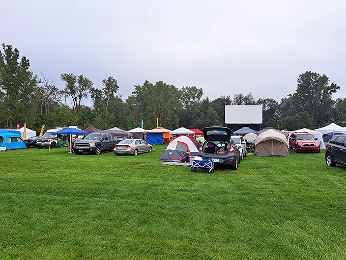 A community forms as vehicles and campers claim their spots, each creating their own perfect movie-watching nest under the open sky.