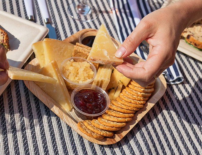 Cheese, crackers, and accompaniments arranged with care that says someone actually wants you to enjoy this, not just photograph it.