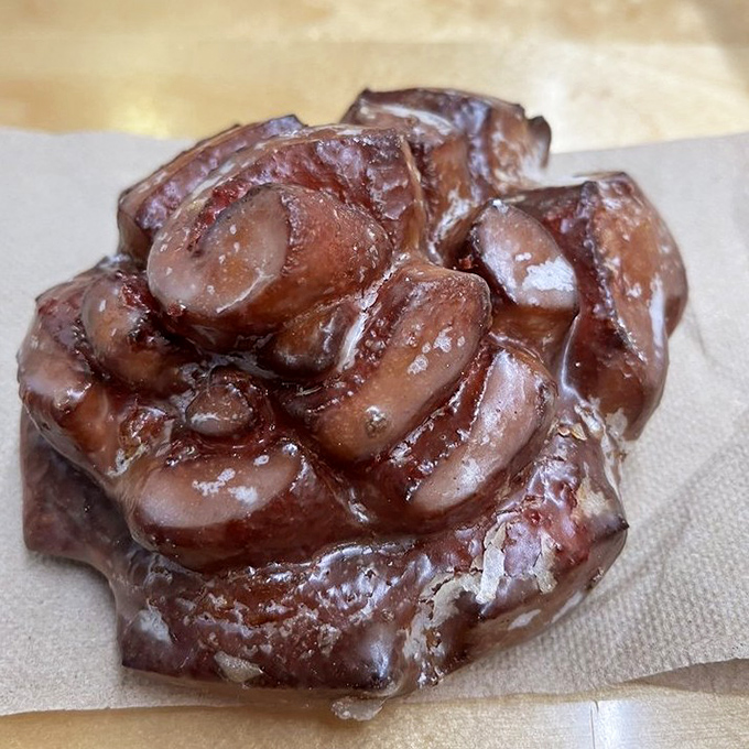 This chocolate-glazed cherry creation hides a sweet secret inside – a burst of fruity filling that requires multiple napkins and zero regrets.