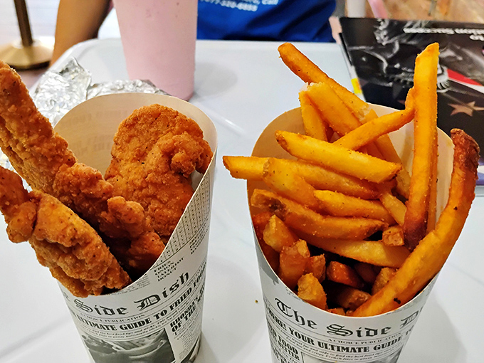Golden-brown chicken tenders nestled alongside perfectly crisp fries &ndash; comfort food that hugs your soul while high-fiving your taste buds.