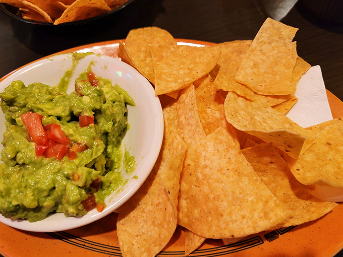 Fresh guacamole studded with diced tomatoes alongside perfectly salted tortilla chips&mdash;the appetizer that's ruined countless appetites for the main course.