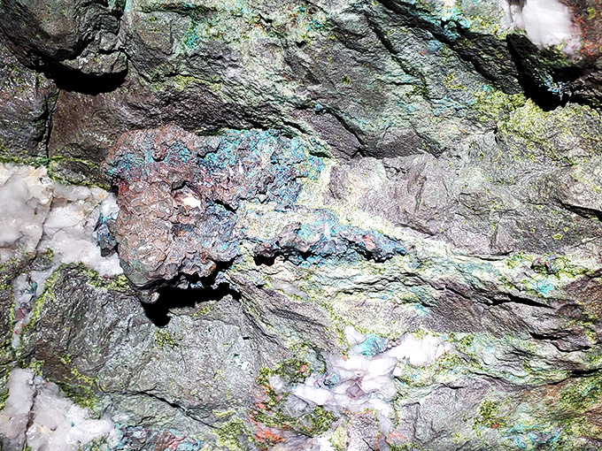Nature's artwork on display: vibrant copper minerals paint the ancient rock walls with blues and greens that no human artist could replicate.