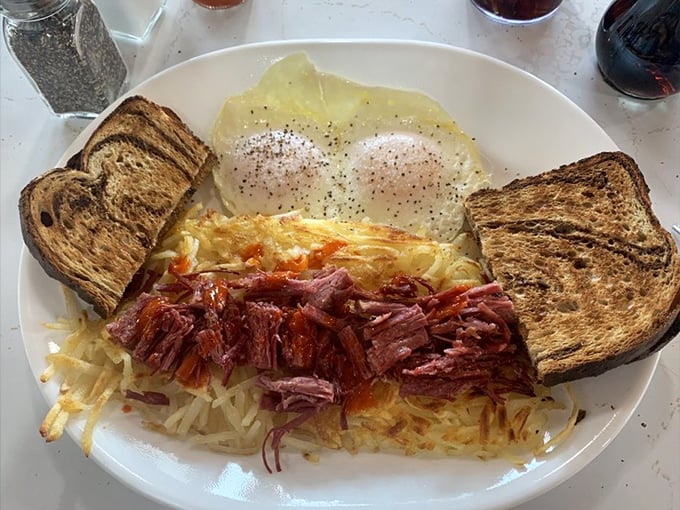 Corned beef hash done right: tender meat, crispy potatoes, perfectly cooked eggs, and toast for good measure.