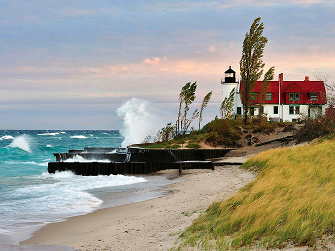 Nature's drama unfolds as powerful waves crash against the shore, demonstrating why this lighthouse was so essential.
