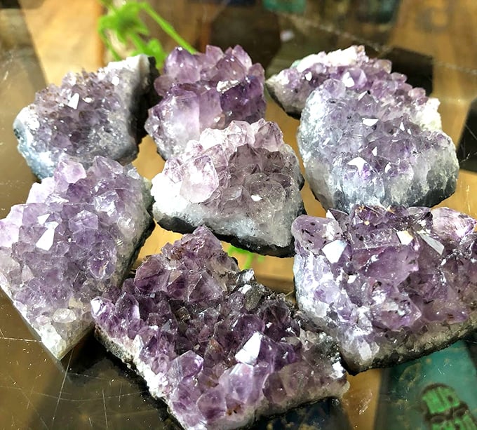 Amethyst clusters shimmer with purple brilliance, appealing to crystal enthusiasts and those simply captivated by nature's geological wonders.