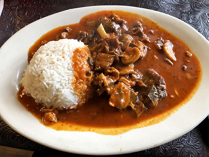 Curry goat: the dish that converts skeptics into believers. That sauce deserves its own fan club and thank-you notes.