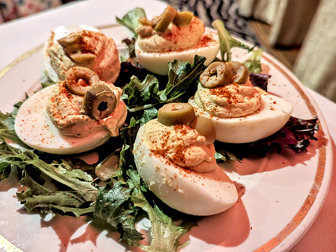 Deviled eggs elevated to art form, each one topped with an olive "eye" that seems to wink at you between bites.