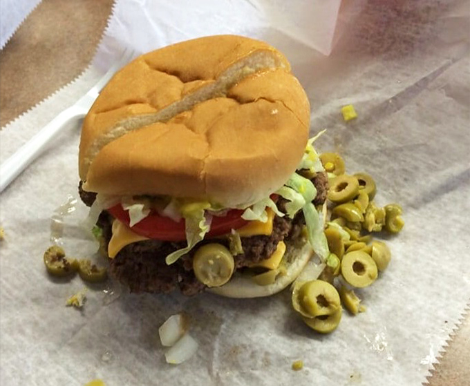 The Michigan specialty olive burger gets the Schlenker's treatment – savory beef topped with tangy olives that create an unexpected flavor symphony.