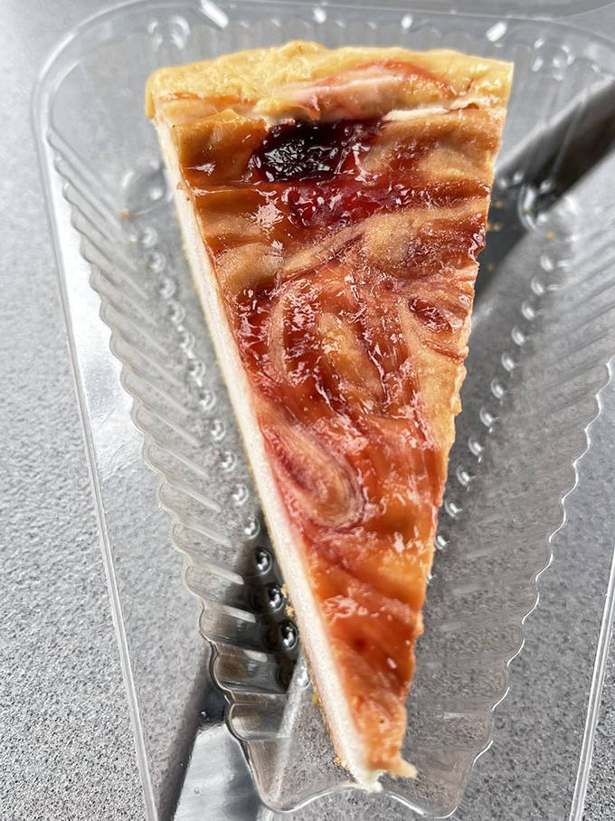 Ribbons of strawberry swirl through this gluten-free masterpiece, proving that "free-from" doesn't mean free from flavor in the hands of skilled bakers.