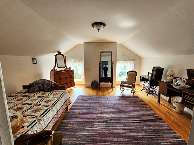 The historic attic bedroom whispers stories of lighthouse keepers past &ndash; simple furnishings and wooden floors that have witnessed countless Lake Superior sunrises.