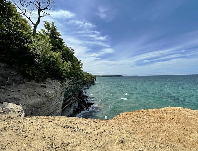 Sandstone cliffs meet crystal waters in a geological handshake that's been perfecting its form for thousands of years.