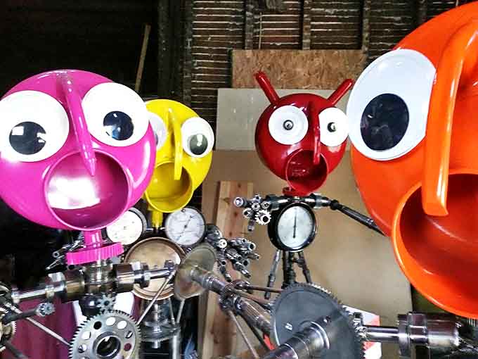 Metal sculptures peer out from a latticed doorway, like curious neighbors wondering who's coming to visit their colorful community.