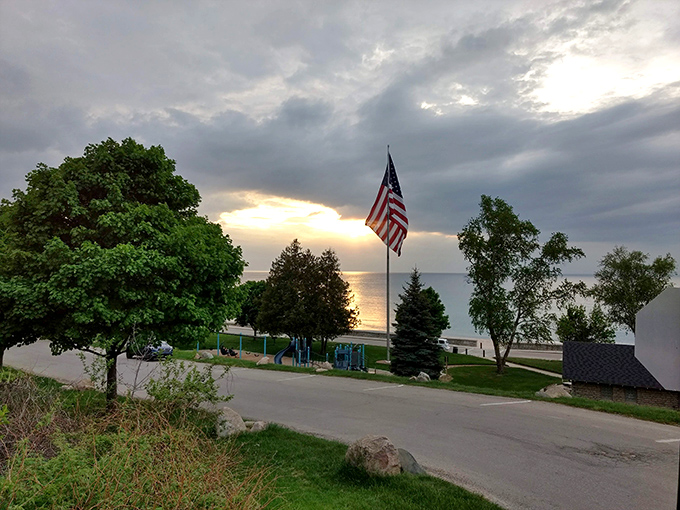 Golden hour magic transforms Michigan Beach Park into a painter's dream as sunset casts long shadows across the shoreline.