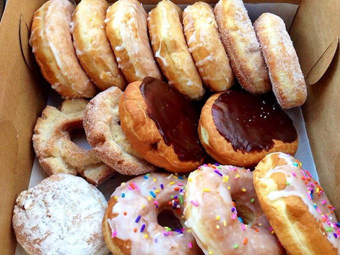 A box of Hans' donuts isn't just pastry – it's a collection of edible art that somehow never makes it all the way home.
