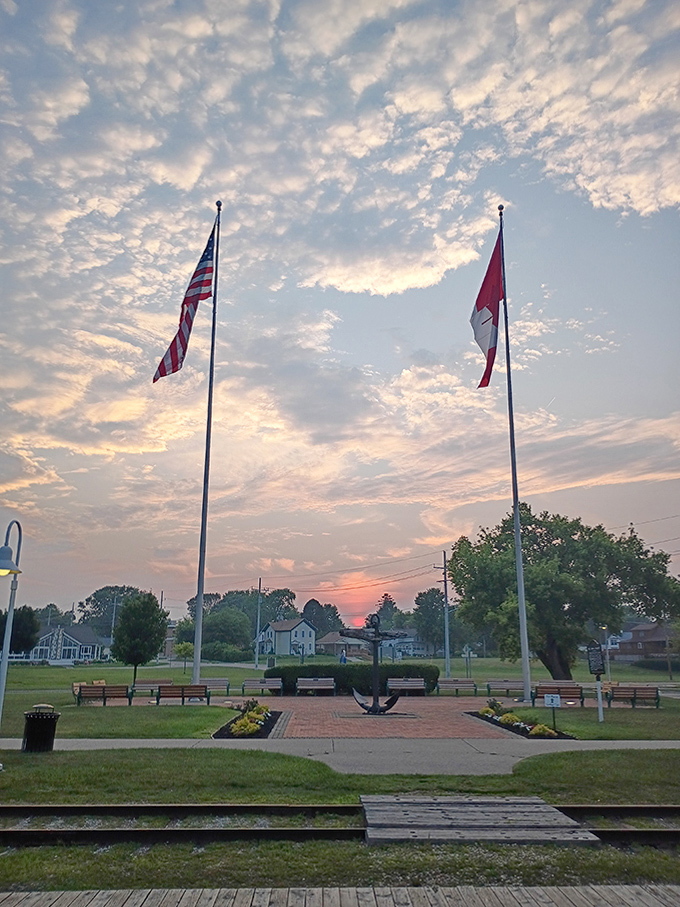 As day surrenders to dusk, American and Canadian flags stand sentinel over the waterway, a reminder of the international friendship spanning these shores.