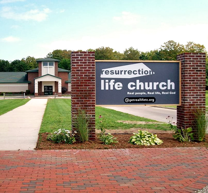 Resurrection Life Church stands as a spiritual landmark, its brick fa&ccedil;ade and welcoming sign inviting both regulars and visitors to find community.
