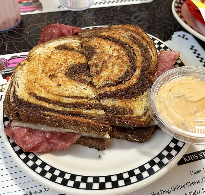 Marble rye bread hugs layers of corned beef and sauerkraut in this Reuben sandwich that would make even New York delis tip their hats in respect.