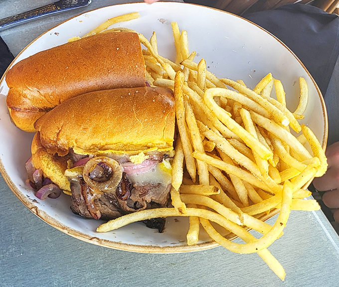 The roast beef sandwich comes loaded with tender meat, melted cheese, and caramelized mushrooms – proof that greatness can happen between two slices of bread.