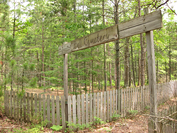 The second entrance to Bell Cemetery, where weathered pickets stand guard over long-forgotten stories and lives once lived.