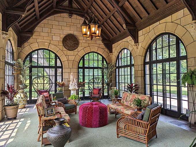 The sun porch offers a bright sanctuary where one could escape the exhausting burden of being fabulously wealthy while surrounded by plants.