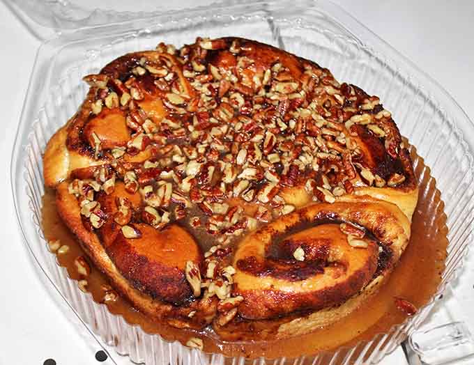 Sticky buns glistening with caramel promise, waiting to transform ordinary mornings into occasions worth remembering.