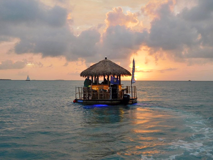 As day surrenders to dusk, a floating tiki bar becomes the best seat in the house for nature's nightly masterpiece.