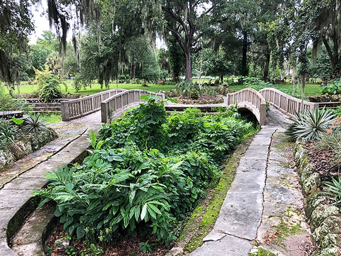 Dual bridges span a sunken garden that once flourished with exotic plants, creating a miniature wonderland within the larger property.
