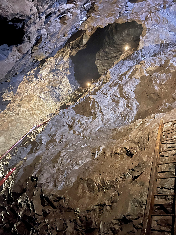 Nature slowly reclaims what man carved out, creating an otherworldly cathedral where mineral-stained walls whisper mining tales.