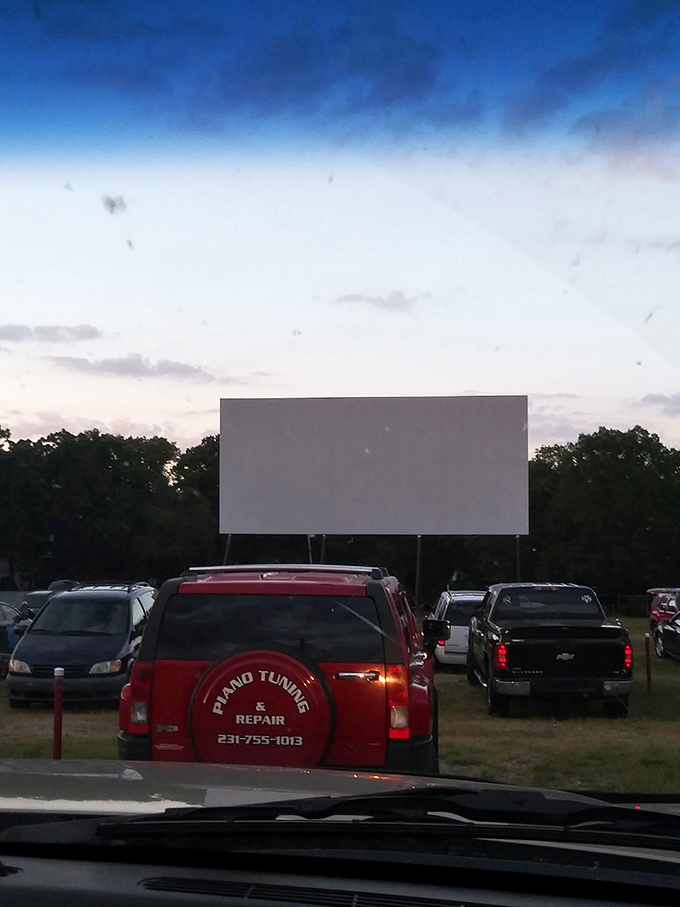 The windshield frames your cinematic experience perfectly, creating a personal portal to Hollywood magic from the comfort of your front seat.
