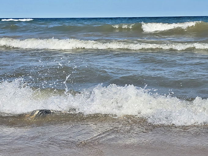 Lake Huron shows its playful side as waves dance toward shore, creating a hypnotic rhythm that washes away everyday stress.