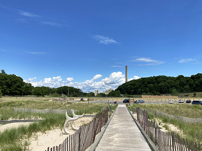 Weathered wooden boardwalks protect fragile dune ecosystems while guiding visitors toward that first breathtaking glimpse of endless blue horizon.