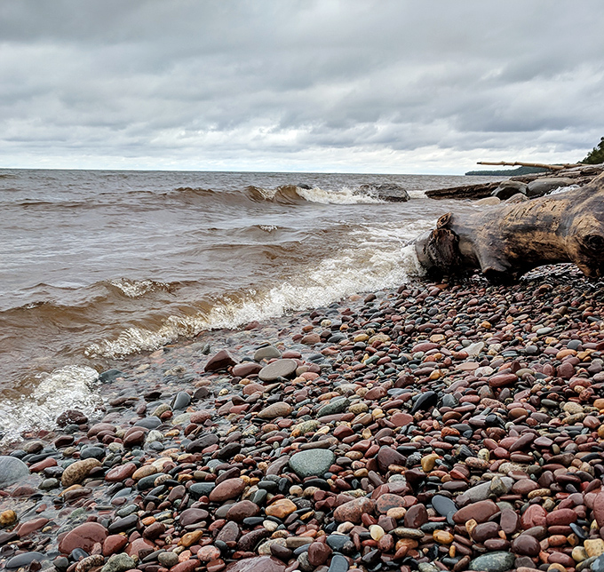 Nature's mosaic: The colorful carpet of stones creates an ever-changing pattern as waves continuously rearrange this geological artwork.