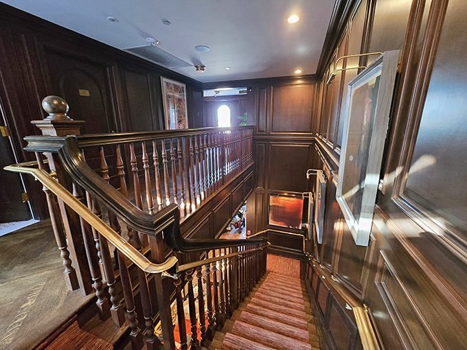 That grand staircase leads to more books, more seating, and more reasons to extend your stay indefinitely.