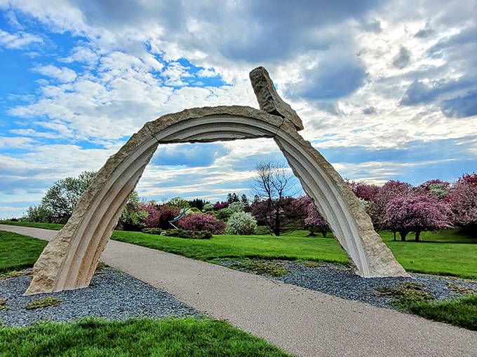This stone arch looks like a portal to another dimension, or at minimum, the kind of landscape feature that makes architects question their life choices.