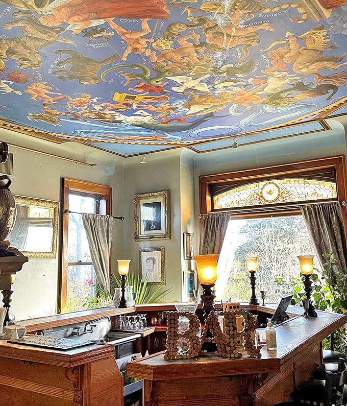 Bar Area: Beneath a painted sky ceiling, amber-glowing lamps cast a warm hue over the bar&mdash;the perfect spot for liquid courage before ghost hunting.