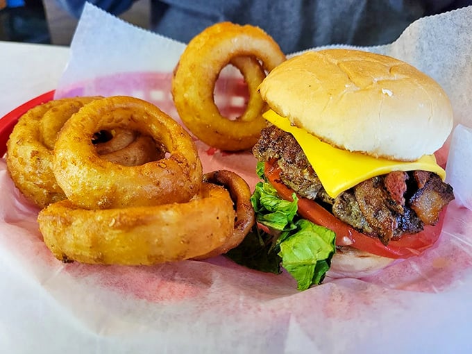 Golden onion rings and a perfectly stacked burger – a classic American duo that proves sometimes the simplest pleasures are the most satisfying ones.