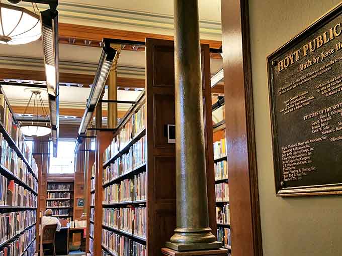 Walking through these stacks feels like strolling through literary history, with iron columns and wooden shelves housing countless worlds between covers.
