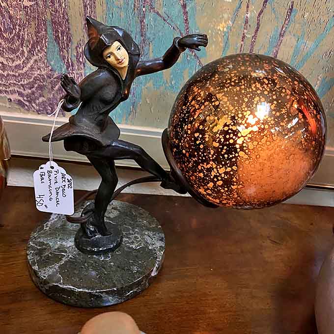 This Art Deco pixie lamp looks like she's either running away with your secrets or delivering good news from the fairy realm.