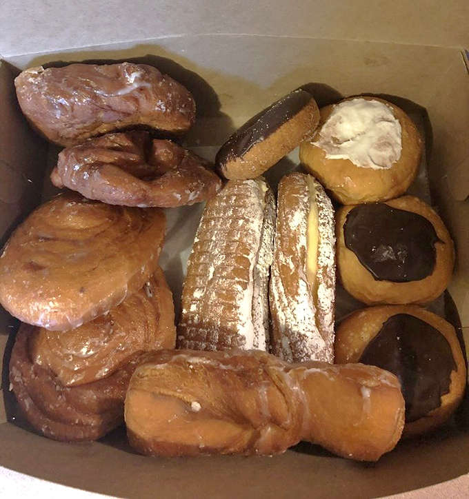 A box of assorted donuts that makes you want to play bakery roulette &ndash; close your eyes, pick one, and prepare for sugary bliss.
