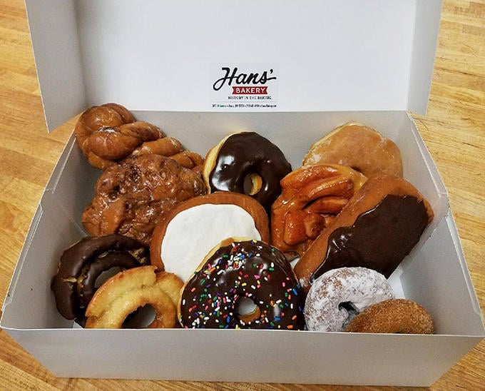 The assorted donut display offers a choose-your-own-adventure of flavors, where there are no wrong choices, only degrees of delight.