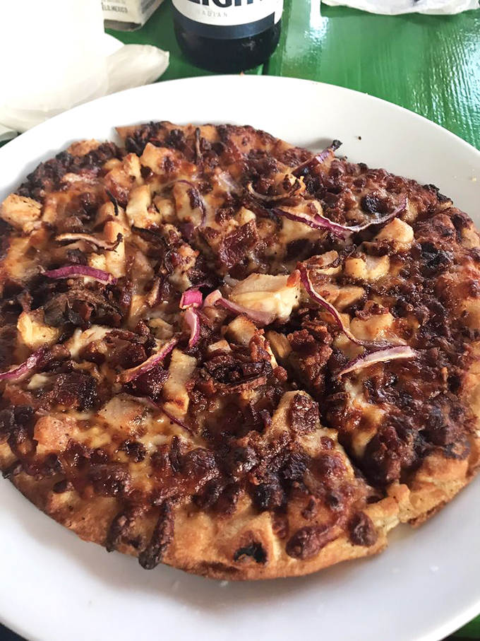 Pizza gets a Caribbean makeover with this BBQ chicken masterpiece&mdash;proof that island inspiration improves everything it touches.