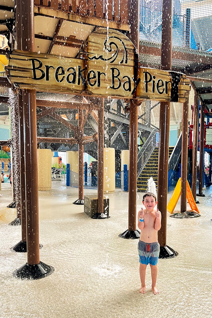 Under the Breaker Bay Pier sign, young adventurers discover the joy of getting thoroughly soaked while parents pretend they're not next in line.