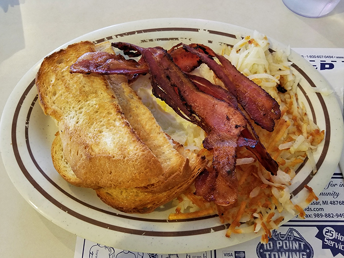 The breakfast that launched a thousand productive days – crispy bacon, golden toast, and hash browns that hit all the right notes.