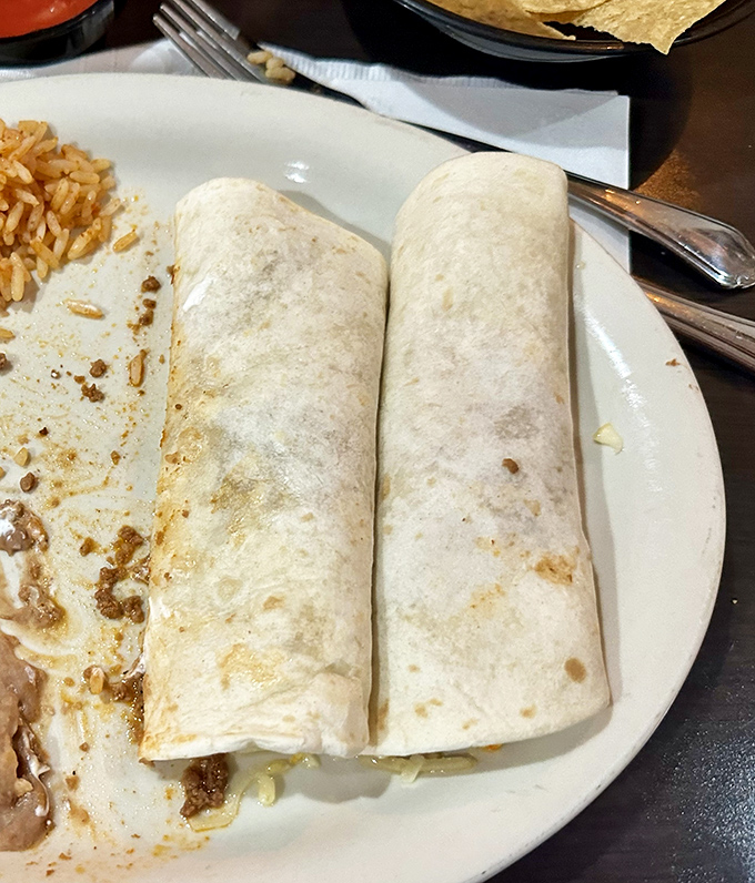These aren't just burritos; they're edible sleeping bags stuffed with dreams of perfectly seasoned fillings and melted cheese.