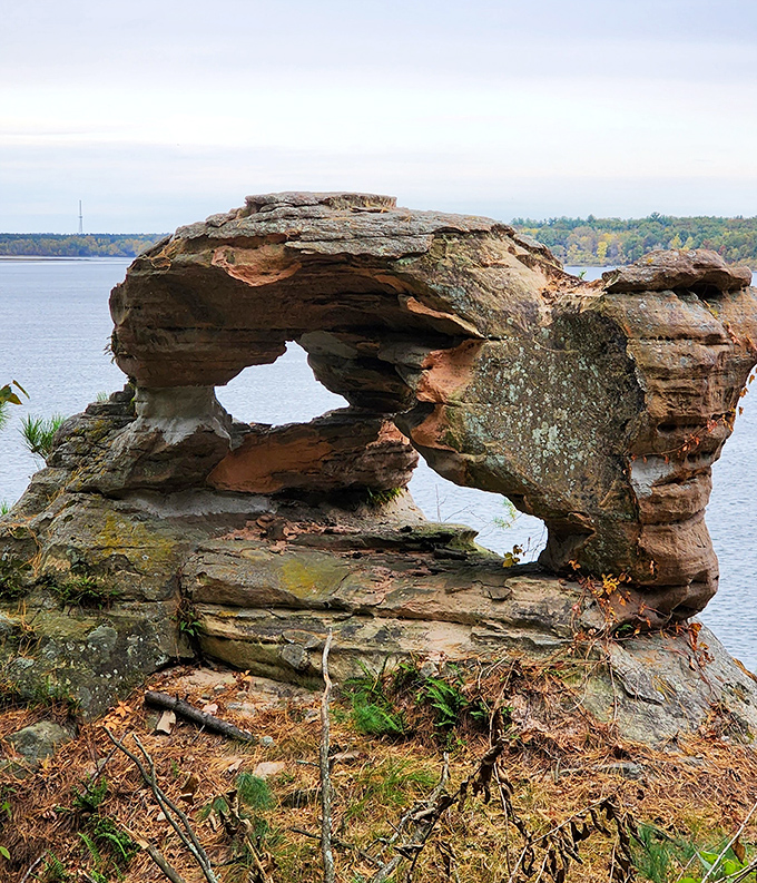 Chapel Rock stands sentinel over the Wisconsin River, its natural arch framing the water beyond. Centuries of patient erosion created this postcard-perfect formation.
