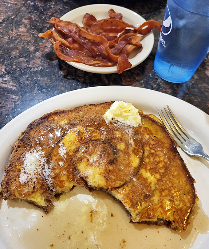 A pat of butter slowly melts into the warm crevices of this breakfast masterpiece, begging for a generous pour of syrup.